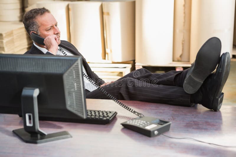 Warehouse Manager Using Telephone at Desk Stock Photo - Image of device ...