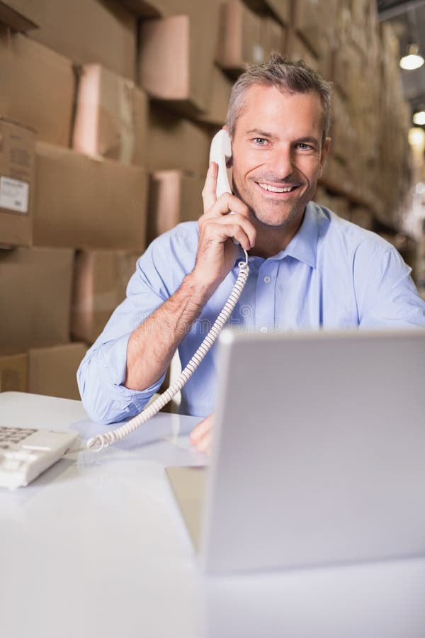 Warehouse Manager Using Telephone and Laptop Stock Photo - Image of ...