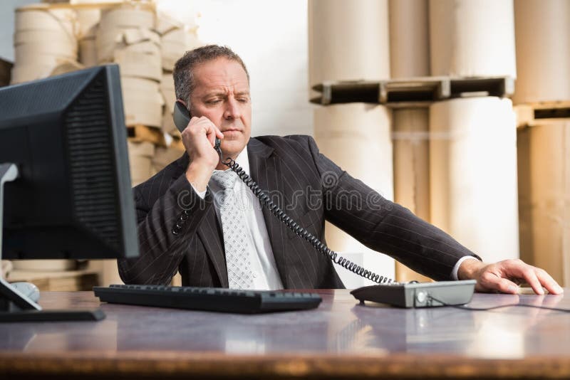Warehouse Manager Using Telephone and Laptop Stock Photo - Image of ...