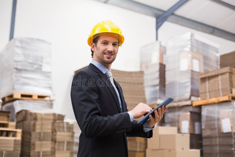 Warehouse Manager Wearing Hard Hat Using Tablet Stock Photo - Image of ...