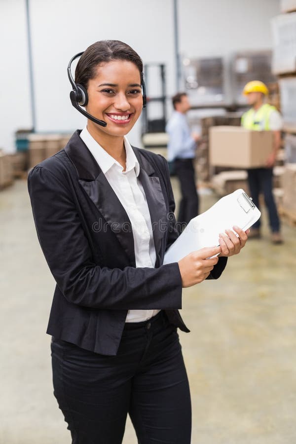 Warehouse Manager Wearing Headset Holding Clipboard Stock Image - Image ...