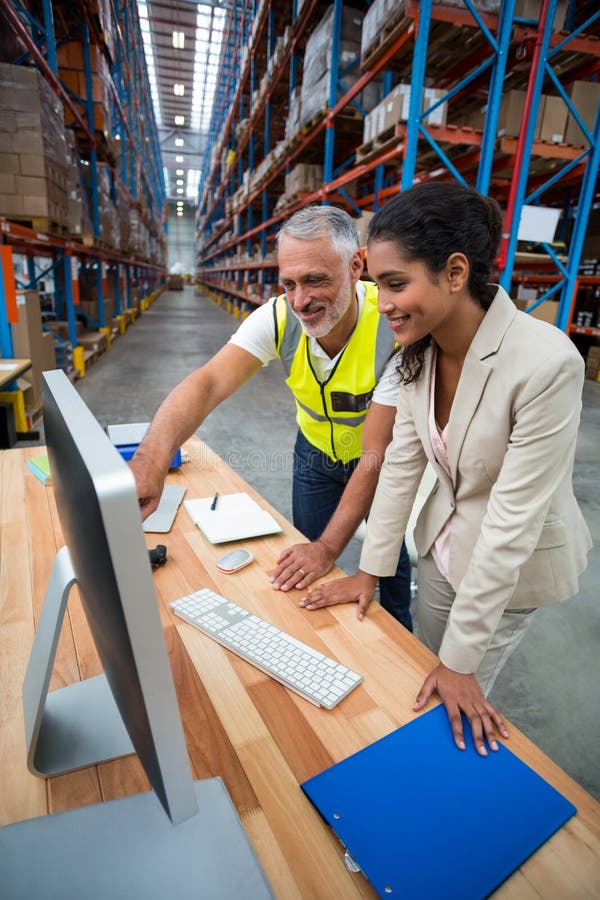 Warehouse Manager and Worker Discussing with Computer Stock Image ...