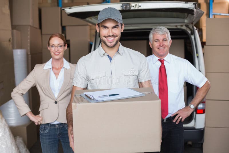 Warehouse Managers and Delivery Driver Smiling at Camera Stock Photo ...