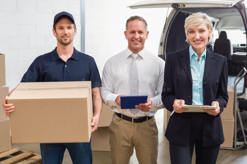 Warehouse Managers and Delivery Driver Smiling at Camera Stock Photo ...