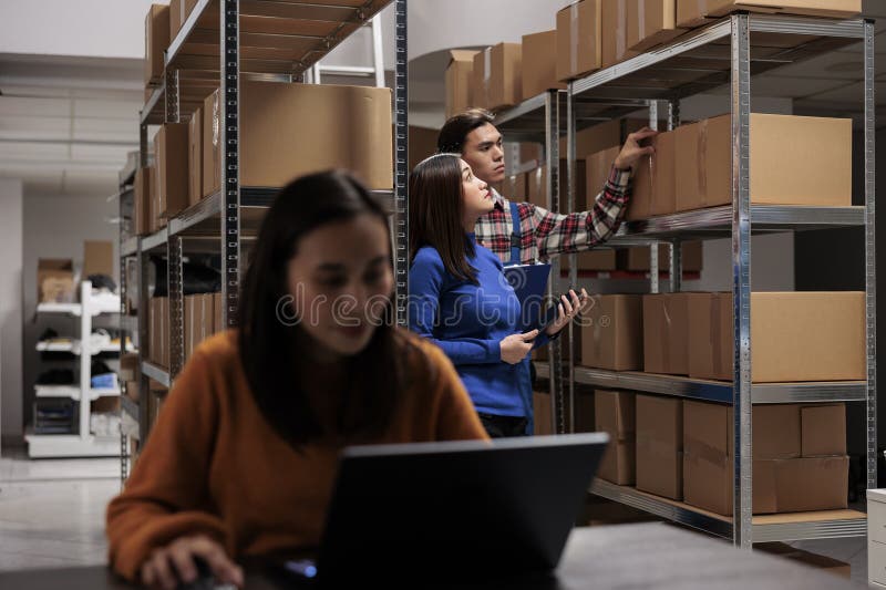 Warehouse Managers Processing Customer Order, Searching Box on Shelf ...