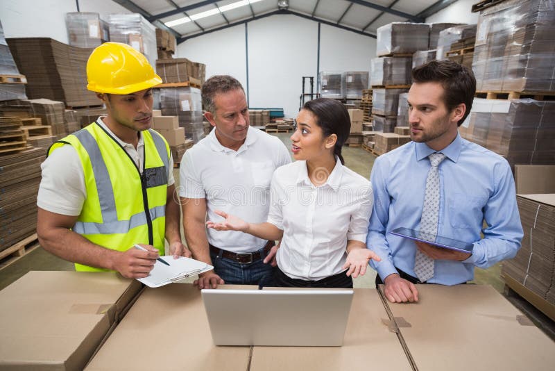 Warehouse Managers and Worker Working on Laptop Stock Image - Image of ...