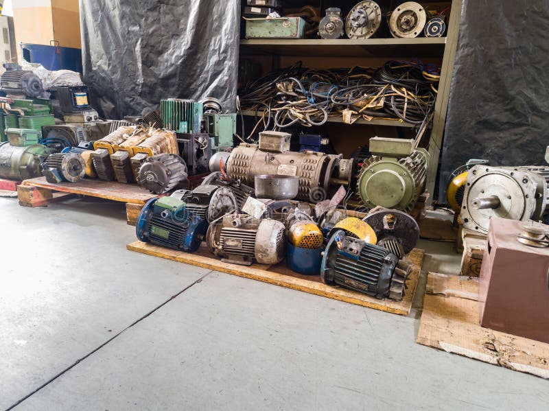 Warehouse of Old Non-working Electric Motors on Racks and on the Floor ...