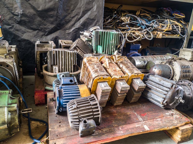 Warehouse of Old Non-working Electric Motors on Racks and on the Floor ...