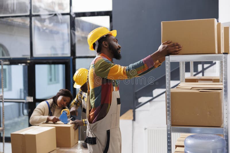 Warehouse Package Handler Choosing Cardboard Box on Shelf Stock Image ...