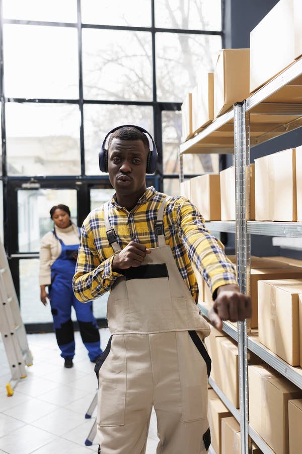 Warehouse Package Handler Dancing at Work Looking at Camera Stock Image ...
