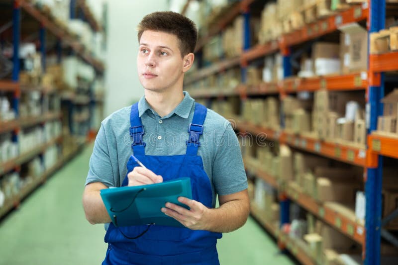 In Warehouse of Store, Guy Checks Quantity of Goods and Receipt ...
