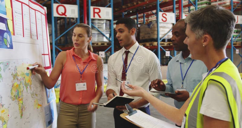 Warehouse Staff in Discussion at an Information Board 4k Stock Footage ...