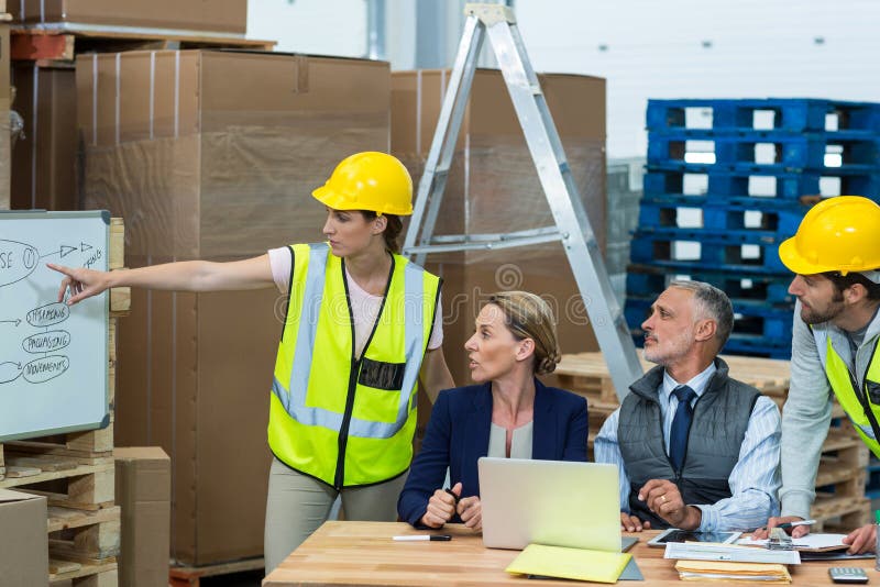Warehouse Team Having a Meeting Stock Photo - Image of helmet, beard ...