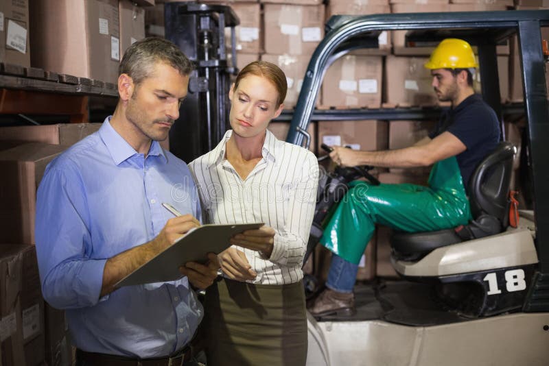 Warehouse Team Working Together with Clipboard Stock Photo - Image of ...