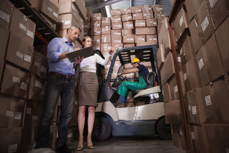 Warehouse Managers Interacting with Workers Stock Photo - Image of ...