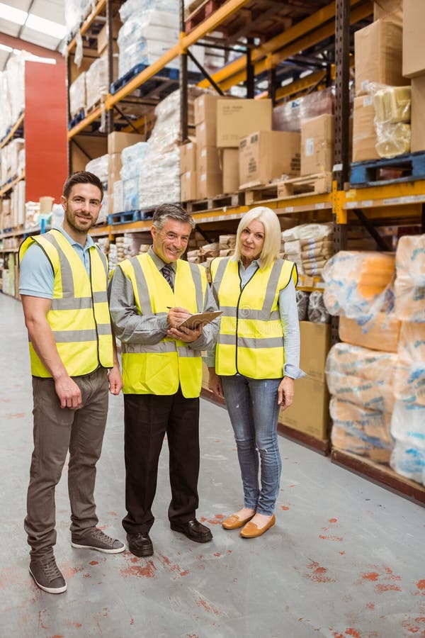 Warehouse Team Working Together Wile Smiling at Camera Stock Photo ... Warehouse Team Working Together Wile Smiling at Camera Stock Photo ...
