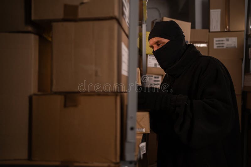 Warehouse Thief Stealing Boxes of Goods at Night. the Concept of ...