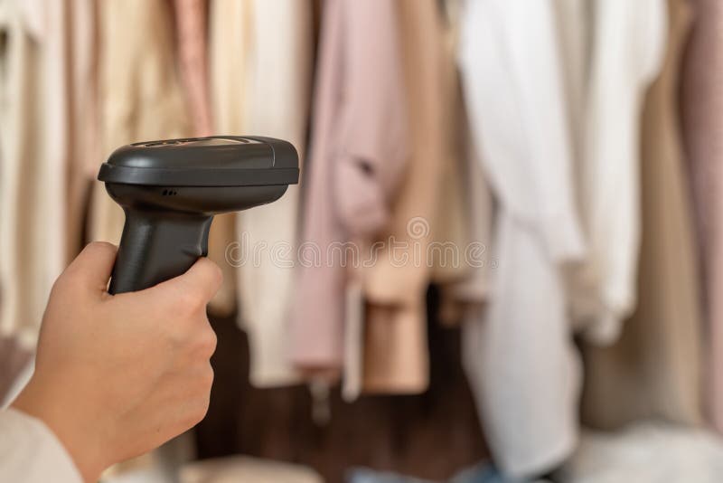 A Warehouse Woman Employee Accepts Clothes Using Barcode Scanner. Stock ...