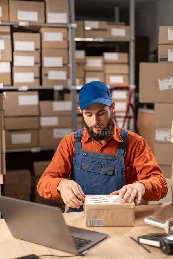 Warehouse Worker Applying Shipping Label on Parcel Boxes. Copy Space ...