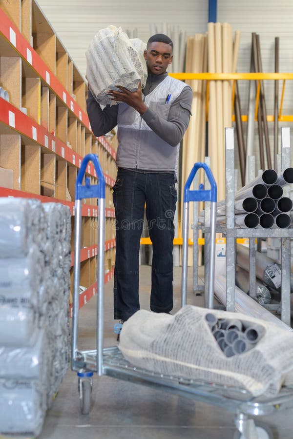 Warehouse Worker Carrying Box in Large Warehouse Stock Image - Image of ...