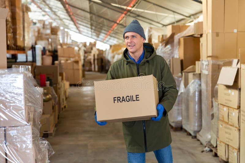 Warehouse Worker Carrying Boxes on Racks in in Warehouse Stock Image ...