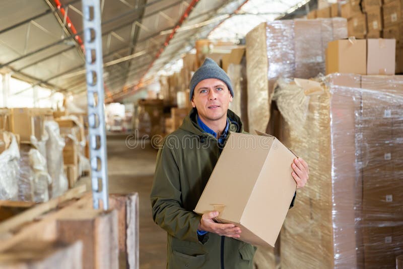 Warehouse Worker Carrying Large Box of Goods in Arehouse Stock Image ...