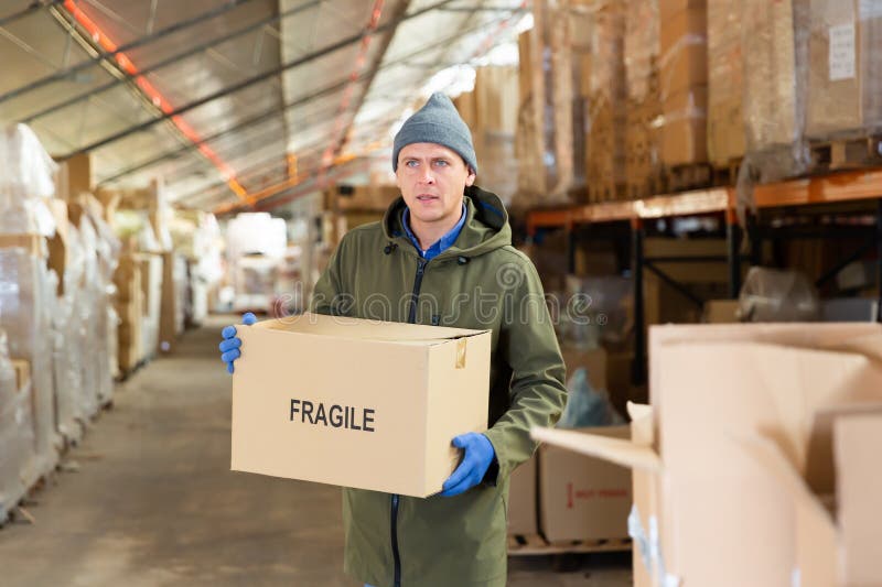 Warehouse Worker Carrying Large Box of Goods in Arehouse Stock Image ...