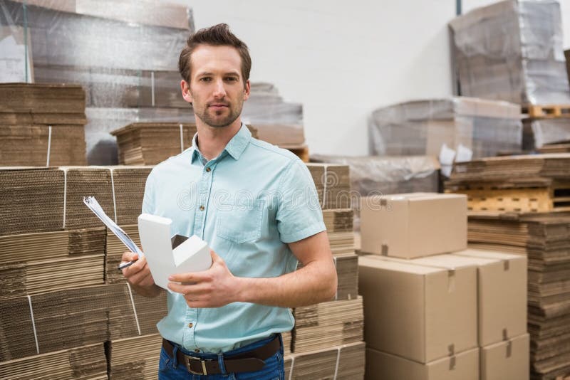 Warehouse Worker Carrying a Small Box Stock Photo - Image of storage ...