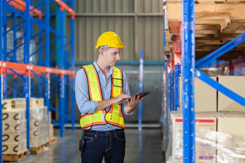 Warehouse Worker with Digital Tablet Checking Inventory in Factory ...