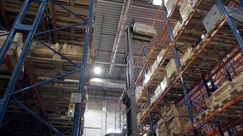 Warehouse Worker Driver in Uniform Loading Cardboard Boxes by Forklift ...