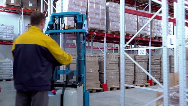 Warehouse Worker Driver in Uniform Loading Cardboard Boxes by Forklift ...