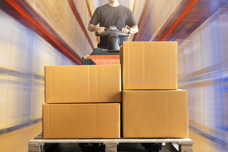 Warehouse Worker with Hand Pallet Truck Unloading Cargo Shipment Goods ...