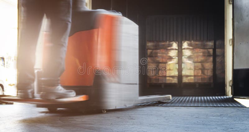 Warehouse Worker Driving Electric Forklift To Unloading Cargo Inside ...