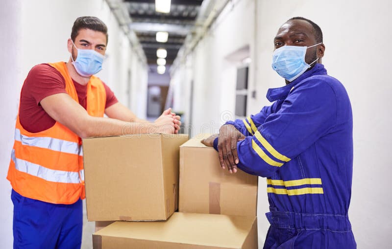 Warehouse Worker with Face Mask because of Covid-19 Stock Photo - Image ...