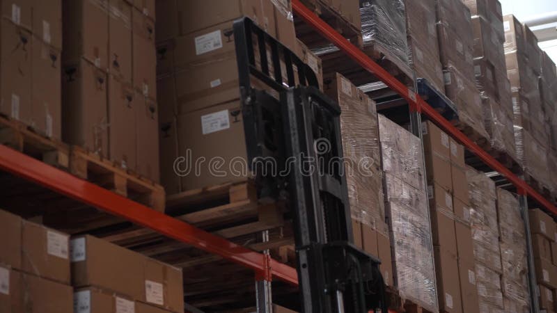 Warehouse Worker on Forklift Placing Load on Shelf Stock Footage ...