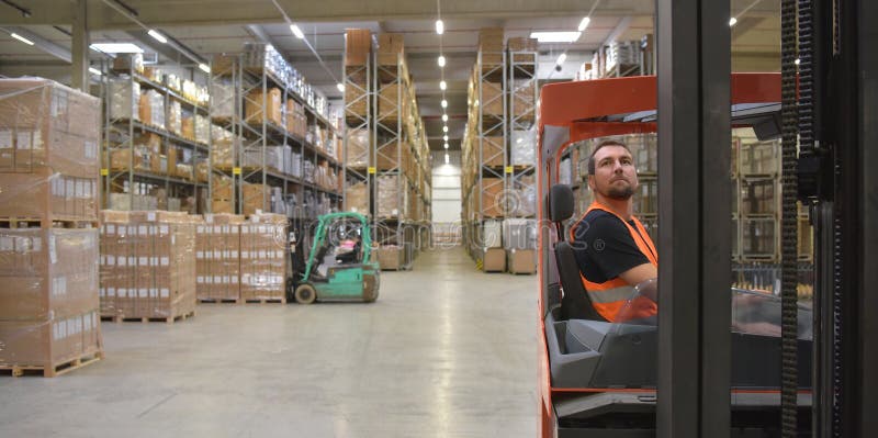 Warehouse Worker in a Forwarding Agency - Interior with Forklift ...