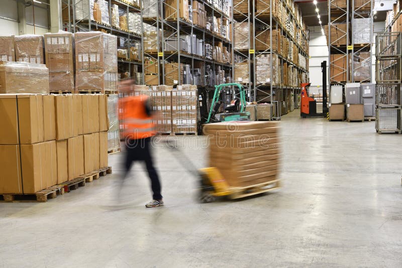 Warehouse Worker in a Forwarding Agency - Interior with Forklift ...