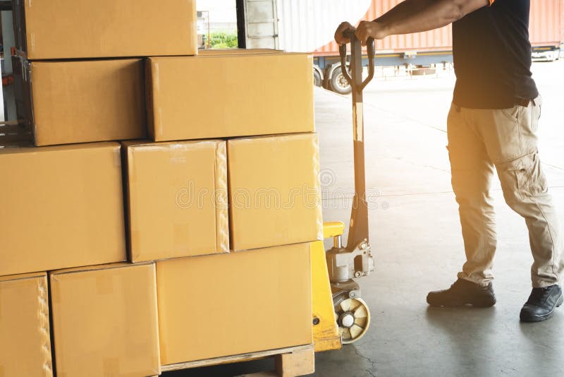 Warehouse Worker with Hand Pallet Truck Unloading Cargo Shipment Goods ...