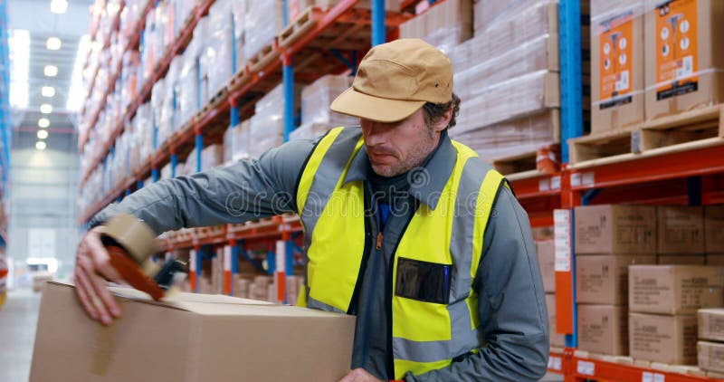 Warehouse Worker Looking at Packages Stock Video - Video of maintaining ...