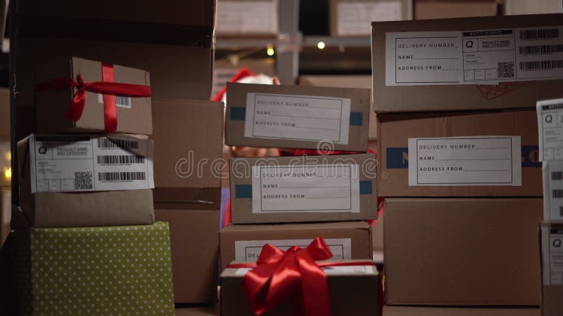 Warehouse Worker Looking for a Parcel on the Shelves Full of Boxes with ...