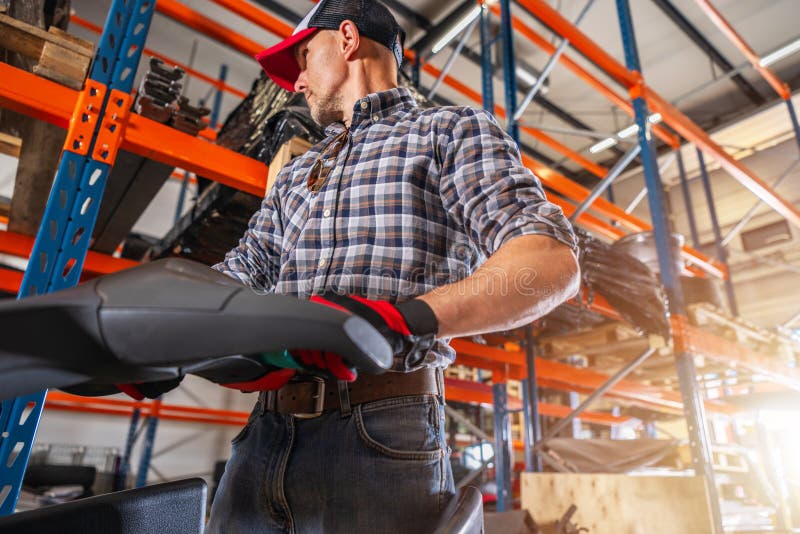 Warehouse Worker Organizing Equipment in a Storage Facility during ...