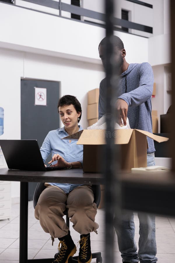 Warehouse Worker Putting Client Order in Cardboard Box Wrapping with ...