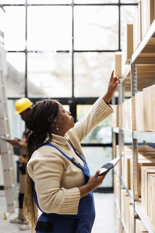 Warehouse Worker Reaching for Parcel at Cardboard Boxes Shelf Stock ...