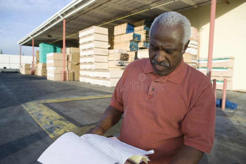 Warehouse Worker Reading Documents Stock Photo - Image of page ...