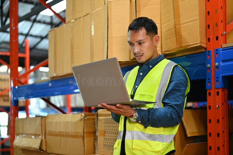 Warehouse Worker in Reflective Jackets Using Digital Tablet, Checking ...