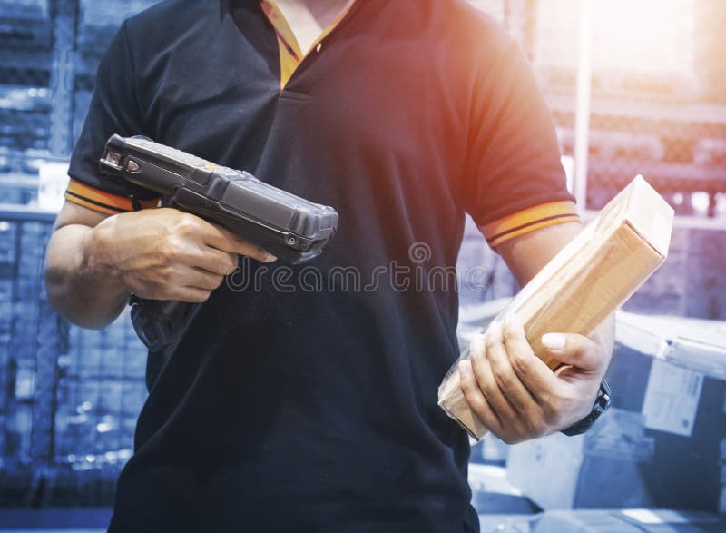 Warehouse Worker Scanning Bar Code Scanner with Package Box. Computer ...