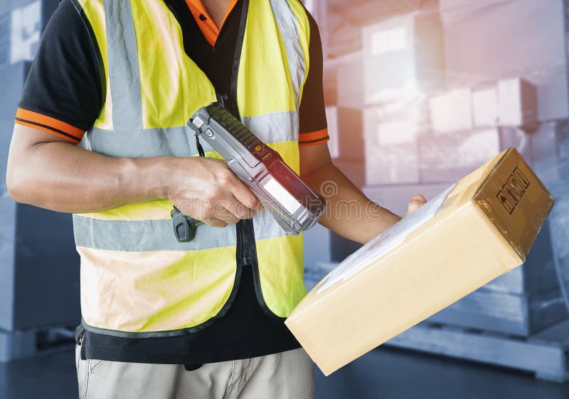 Warehouse Worker Scanning Bar Code Scanner on Package Boxes. Computer ...