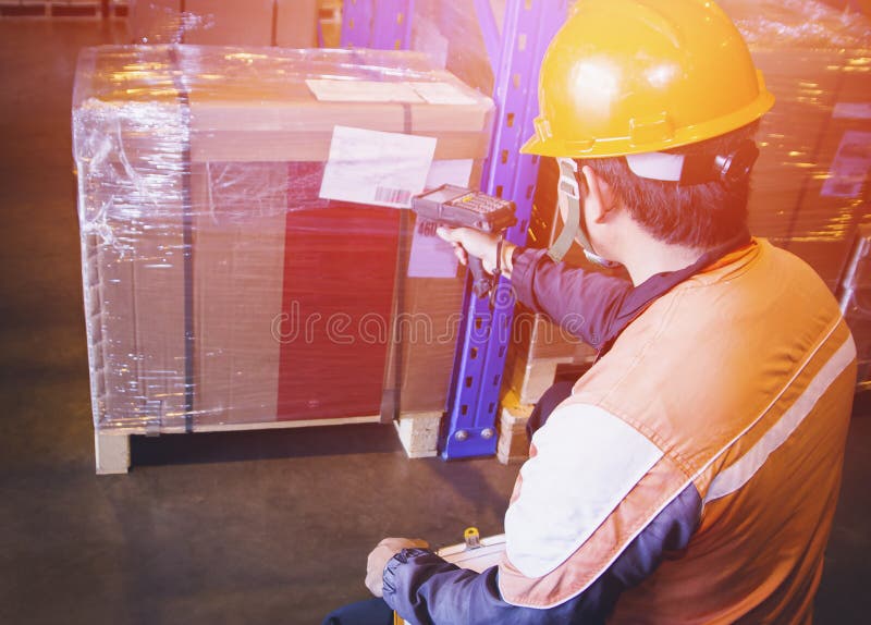 Warehouse Worker Scanning Bar Code Scanner on Package Boxes. Computer ...