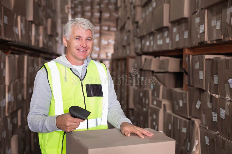 Male Warehouse Worker Scanning Box with Barcode Scanner in Narrow Aisle ...