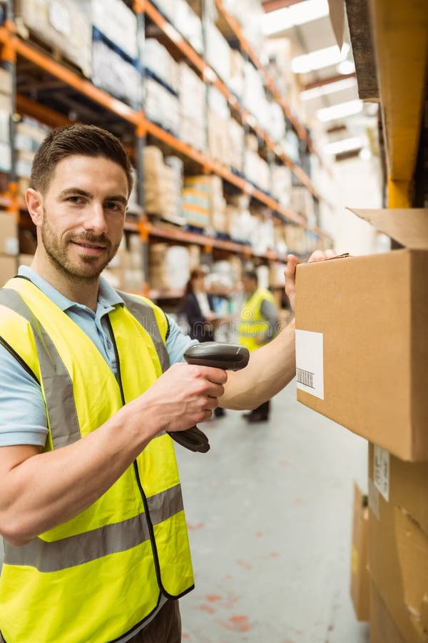 Warehouse Worker Scanning Box while Smiling at Camera Stock Photo ...